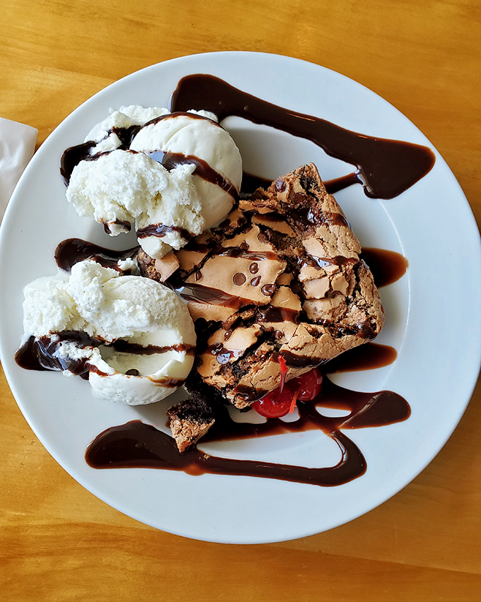 This brownie sundae situation with whipped cream and chocolate drizzle should come with a warning label for restraint.