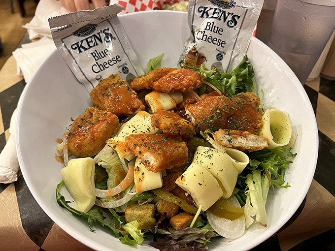 Ken's Blue Cheese packets stand guard over crispy buffalo chicken. A salad that makes you forget you ordered a salad.