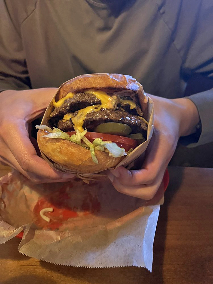 This isn't just a burger &ndash; it's a hand-held masterpiece of beef, cheese, and fresh veggies. The wrapper suggests containment, but your taste buds suggest surrender.