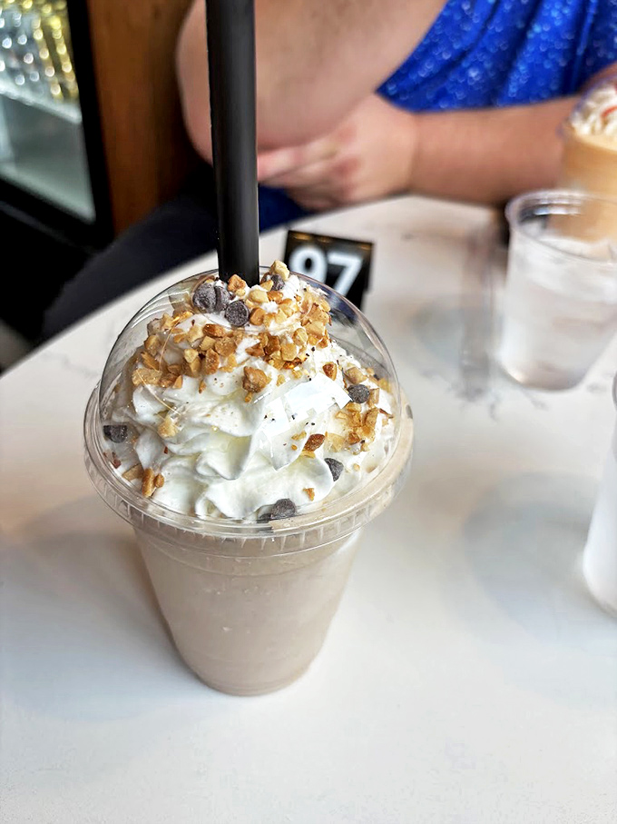 This isn't just a milkshake; it's a Butterfinger masterpiece topped with whipped cream and crunchy bits&mdash;dessert masquerading as a beverage.