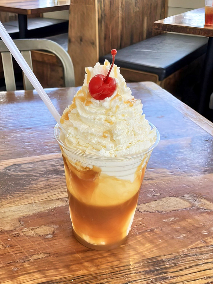 A caramel sundae topped with whipped cream and a cherry&mdash;dessert architecture that belongs in the Louvre of frozen treats.