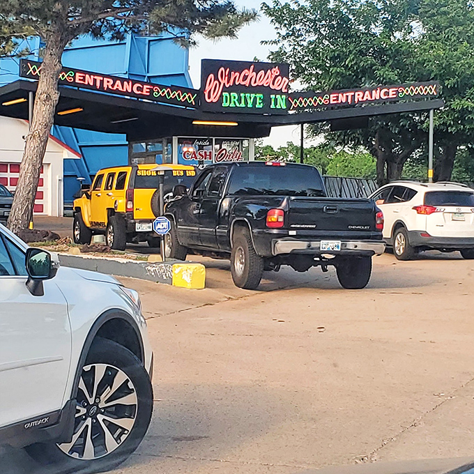 The ritual begins at the entrance gate, where vehicles line up like eager moviegoers from another era, ready for their silver screen adventure.