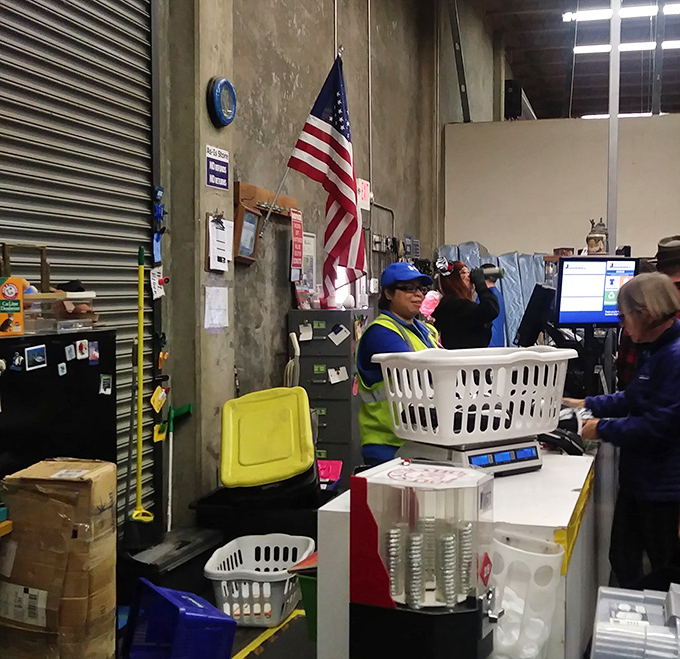 The finish line of the treasure hunt marathon. After winning the blue bin battle, victorious shoppers weigh their spoils at checkout.