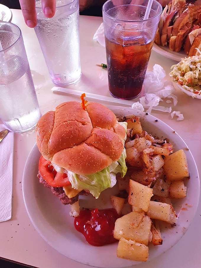 This isn't just lunch&mdash;it's a symphony of textures where juicy burger meets crisp lettuce and home fries play the perfect supporting role.