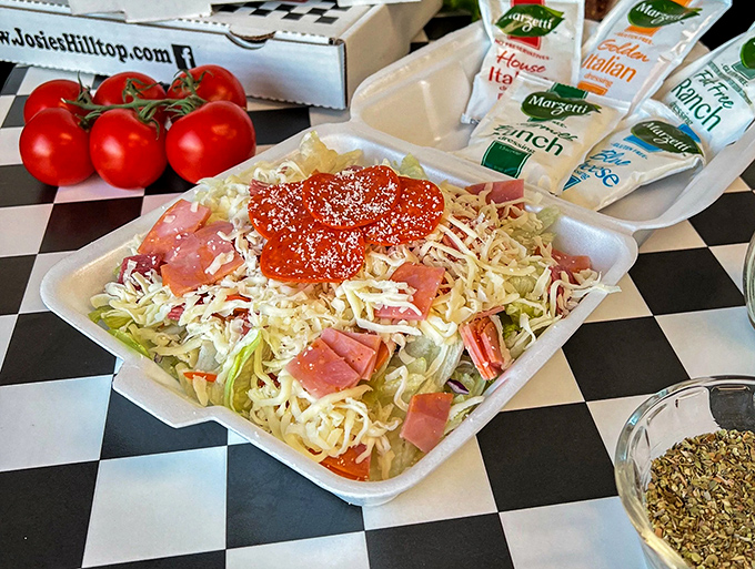 This chef's salad isn't trying to win any beauty contests, but with ham, cheese, and that dollop of dressing, it's the reliable sidekick to your pizza adventure.