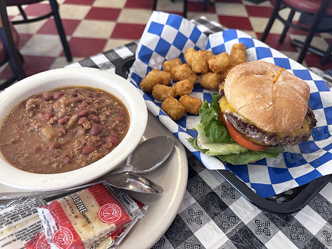 Comfort food diplomacy: a hearty bowl of chili alongside a perfectly dressed burger. This lunch combo has solved more problems than most therapists.