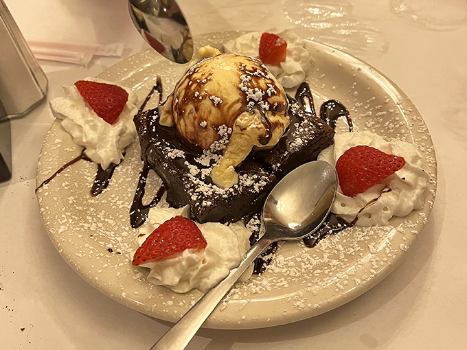 Chocolate cake crowned with ice cream and surrounded by whipped cream&mdash;because you can't spell dessert without the word "stress reliever."