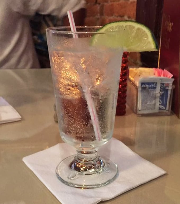 A properly garnished cocktail catching the light just right&mdash;like liquid jewelry with that lime wedge crown. Refreshment that doubles as eye candy.