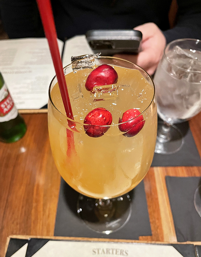 This cocktail isn't just a drink, it's liquid sunshine garnished with cranberries&mdash;the kind of beverage that makes you forget checking your phone exists.