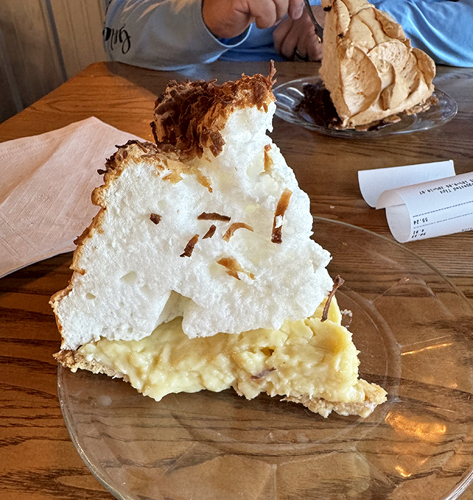 This isn't just pie &ndash; it's a towering cloud of meringue floating above a sea of custard, the kind of dessert that demands a moment of reverential silence.