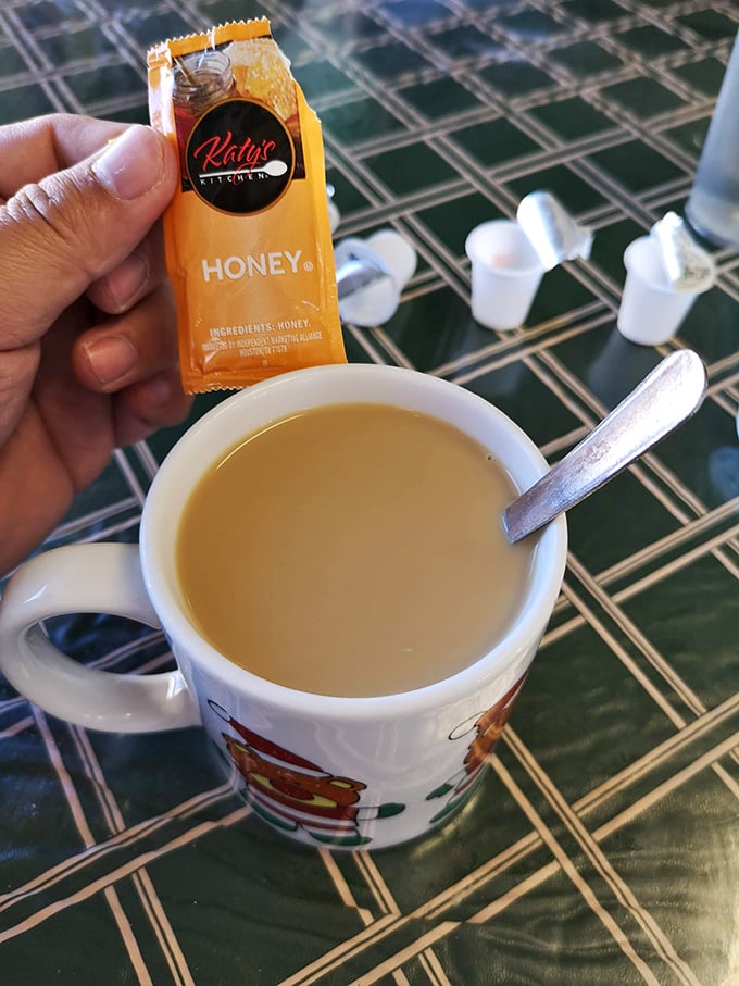 Coffee served with honey packets&mdash;because sometimes the simple pleasures are what truly matter. That festive mug suggests every day is worth celebrating.