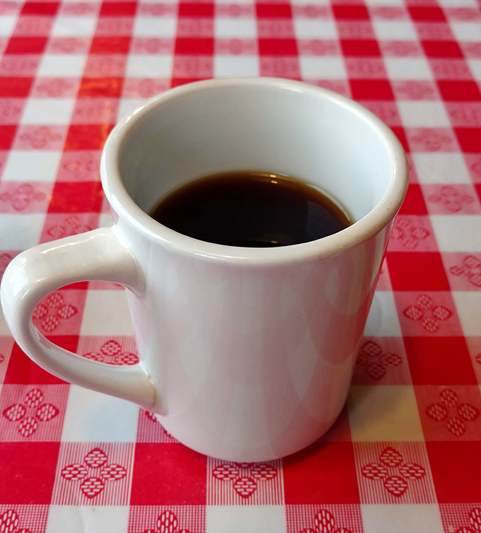 Simple pleasures: Hot coffee in a sturdy white mug on a classic red-checkered tablecloth. Some relationships are complicated&mdash;this one isn't.