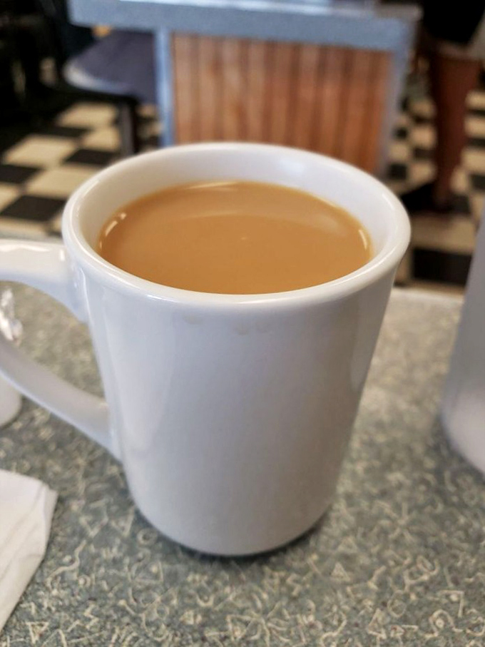 Coffee in a classic white mug &ndash; the unsung hero of every great diner experience. No fancy latte art, just honest caffeine.