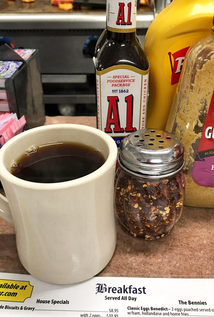 That thick white mug holds the lifeblood of morning warriors&mdash;honest diner coffee that doesn't need fancy Italian names to get the job done.