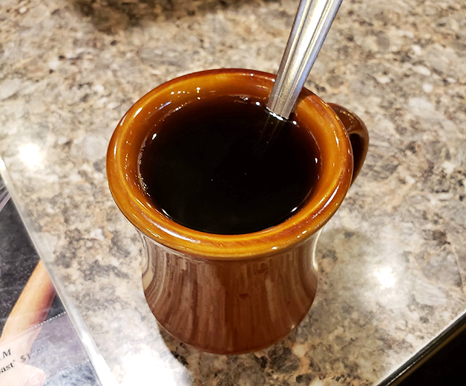 Diner coffee in a proper mug&mdash;dark as midnight, hot as sin, and essential as oxygen for starting the day right.