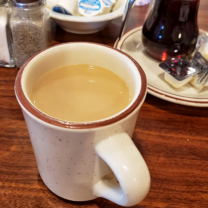 The humble white mug&mdash;civilization's most perfect delivery system for caffeine. In diners like this, refills arrive before you realize you need them.