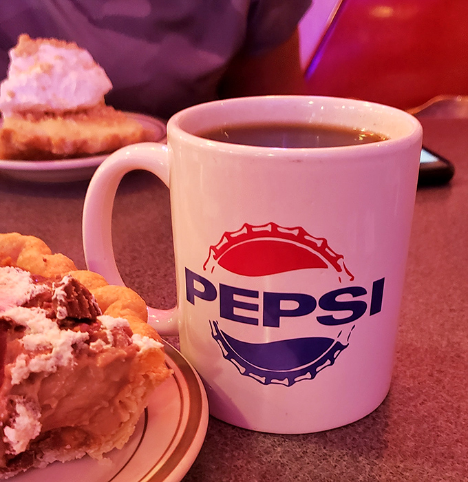 Coffee in a Pepsi mug with pie on standby&mdash;the diner equivalent of having your accountant on speed dial during tax season. Essential.
