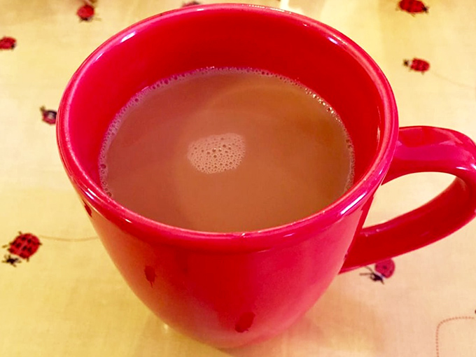 That red mug isn't just holding coffee&mdash;it's cradling liquid motivation, the essential fuel for conversations that meander like the Mississippi River.