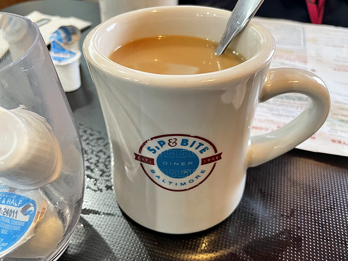 The humble coffee mug, branded with diner pride, delivers liquid motivation that's kept Baltimore moving since before your smartphone existed.