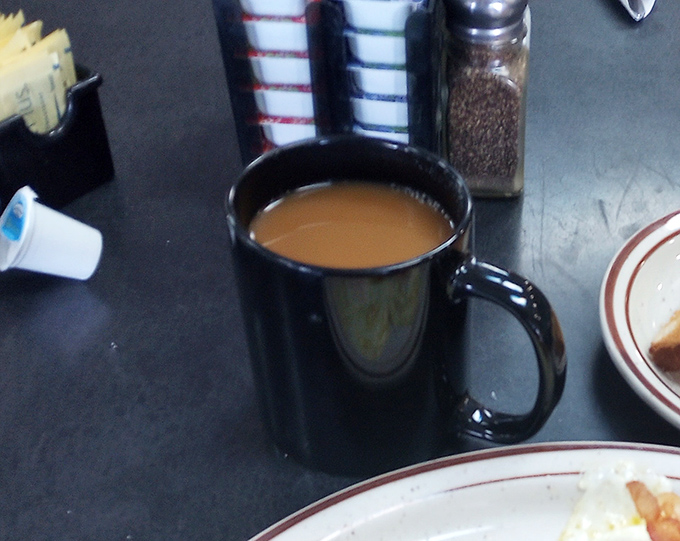 That classic black diner mug isn't just holding coffee&mdash;it's cradling liquid motivation that's fueled American mornings since time immemorial.