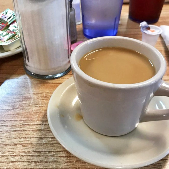 Coffee strong enough to wake the dead, served in cups that have witnessed countless conversations.