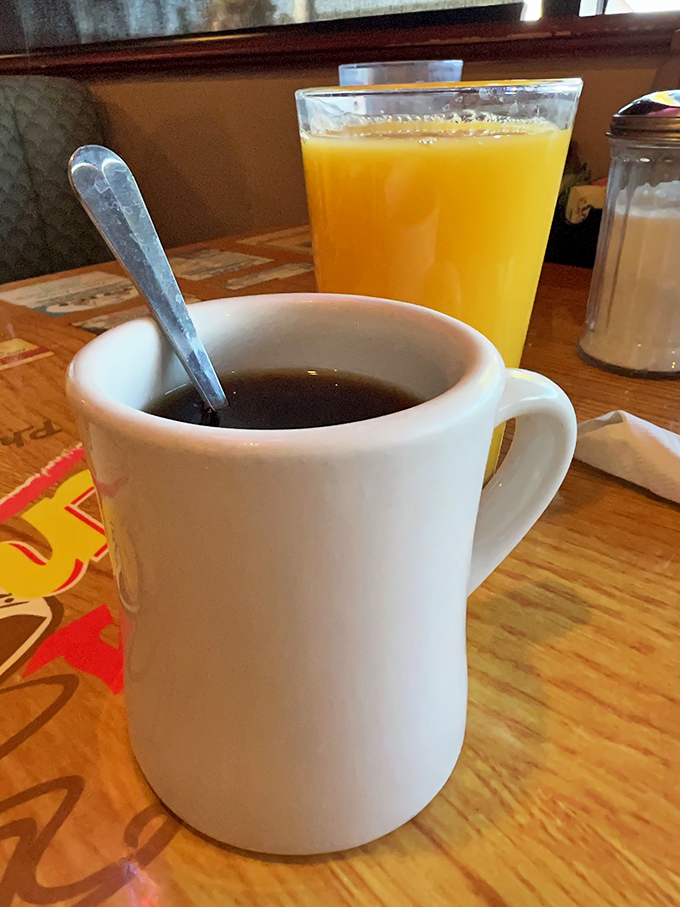 The classic diner duo&mdash;strong coffee in a sturdy mug and orange juice that actually looks like it remembers being fruit. Morning perfection.