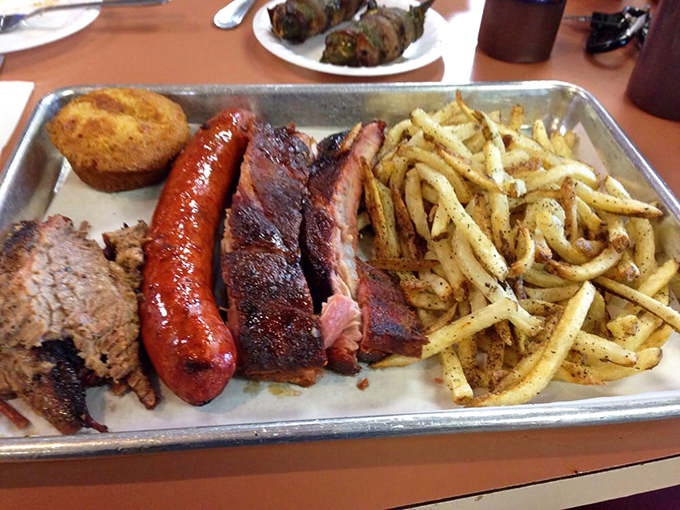The BBQ sampler platter – nature's perfect answer to indecision. Why choose one meat when you can have the United Nations of smoked goodness?