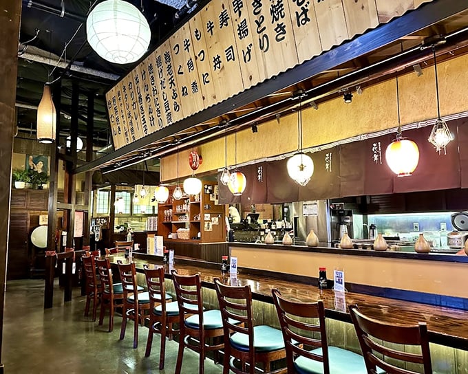 The counter seating offers dinner and a show&mdash;chefs orchestrating a culinary symphony while lanterns cast that perfect "everyone looks good" lighting.