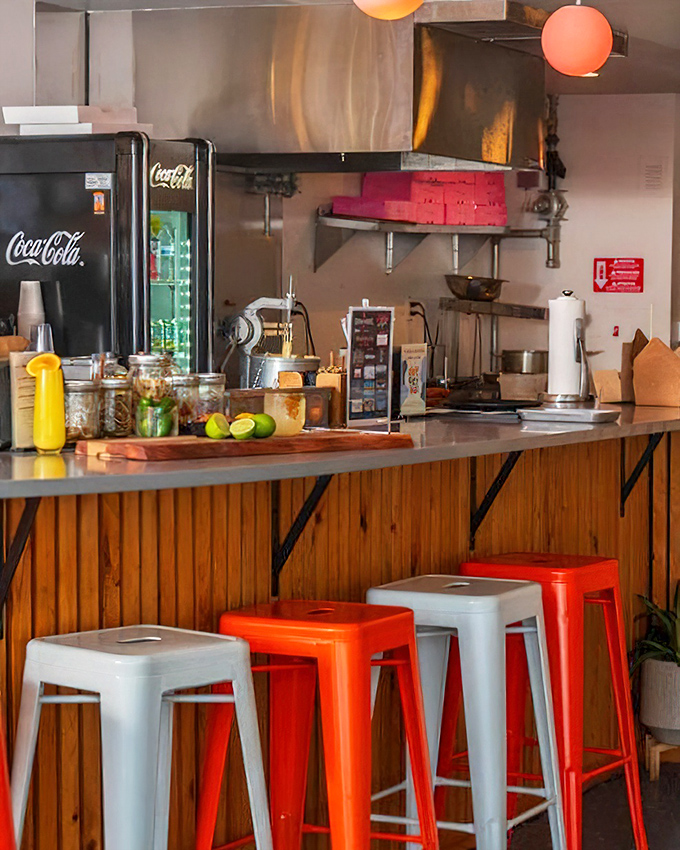 The counter seating area, where wooden panels meet industrial stools, creating that perfect "discovered gem" atmosphere every food lover craves.