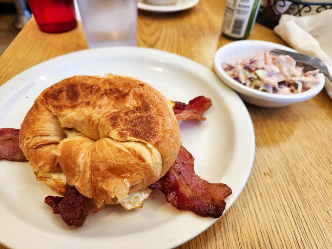 The croissant sandwich&mdash;where buttery pastry meets crispy bacon in a breakfast love story that makes Monday mornings bearable again.