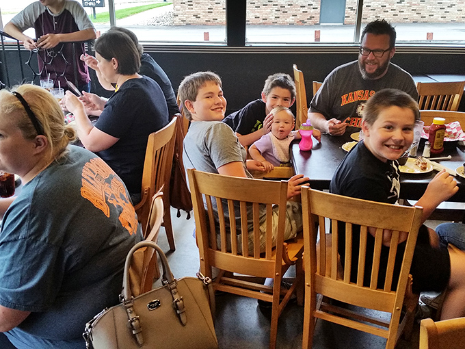Families gather around tables at Sneaky's, creating memories seasoned with laughter and the shared joy of a meal worth remembering.