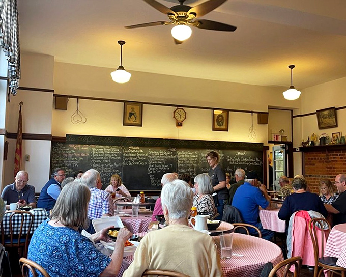 The dining room buzzes with the energy of people who've discovered something special. That chalkboard in back holds the secrets to happiness.