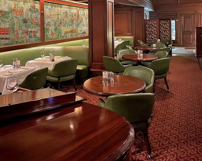 The lounge area offers a more casual vibe with plush green chairs and warm wood tones &ndash; like your wealthy uncle's study, but with better food.