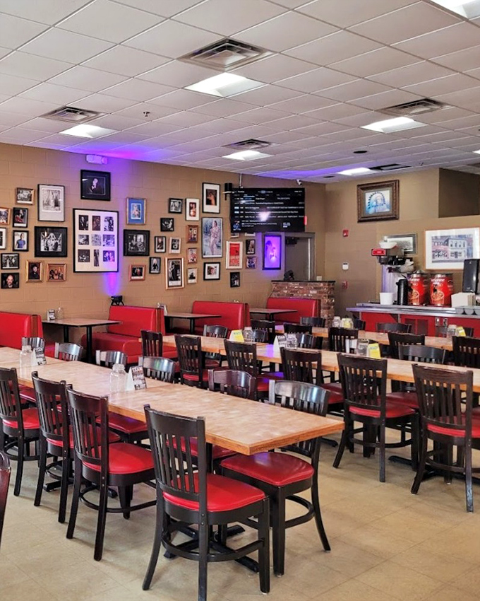 Red chairs await hungry patrons in a dining room where photos tell stories of Nashville's past while plates create memories.