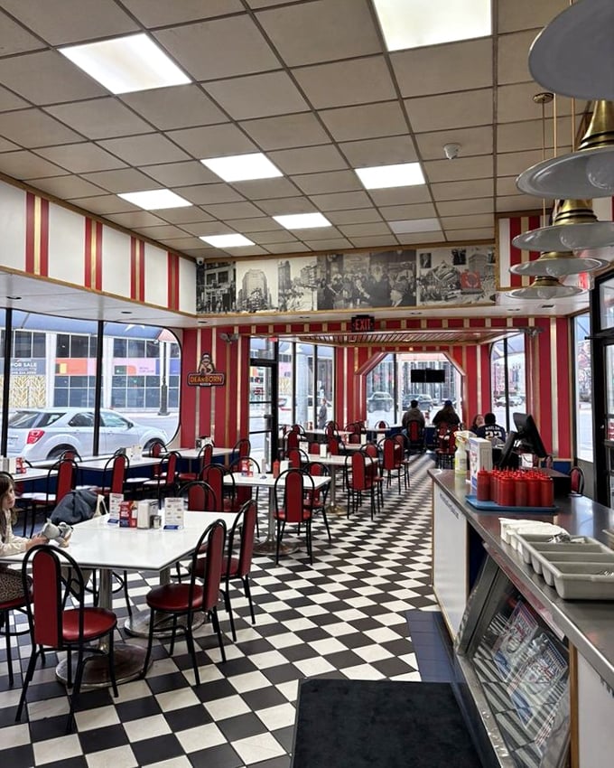 The dining area feels like a time capsule of Americana, where every red stripe and checkered tile tells a story of Detroit's resilient spirit.
