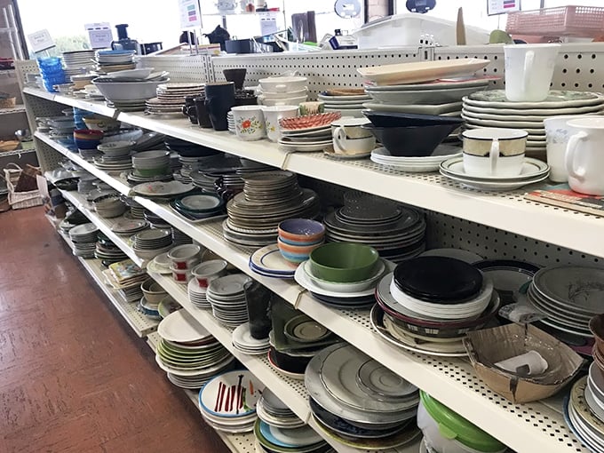 Plates stacked like geological layers &ndash; each pattern a time capsule from someone's dinner parties of decades past.