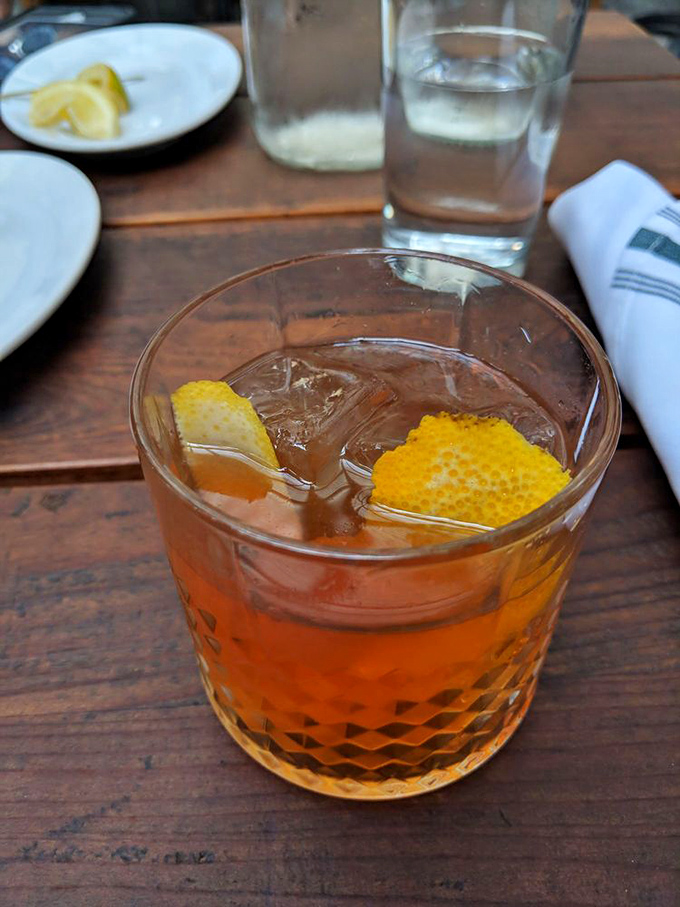 This isn't just a cocktail; it's liquid amber sunshine with a honeycomb garnish that transforms happy hour into happier hour.