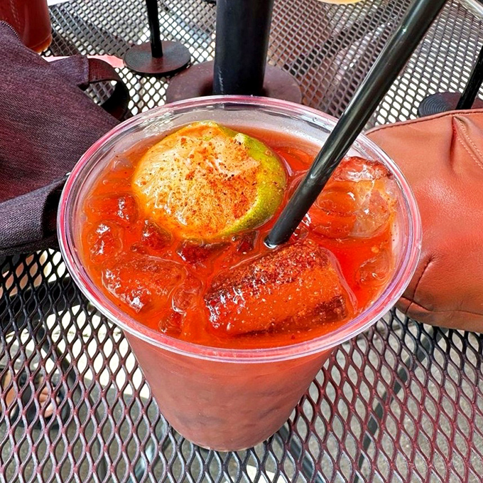 That spicy red concoction with a lime garnish isn't just a drink&mdash;it's liquid courage for the flavor adventure that awaits.