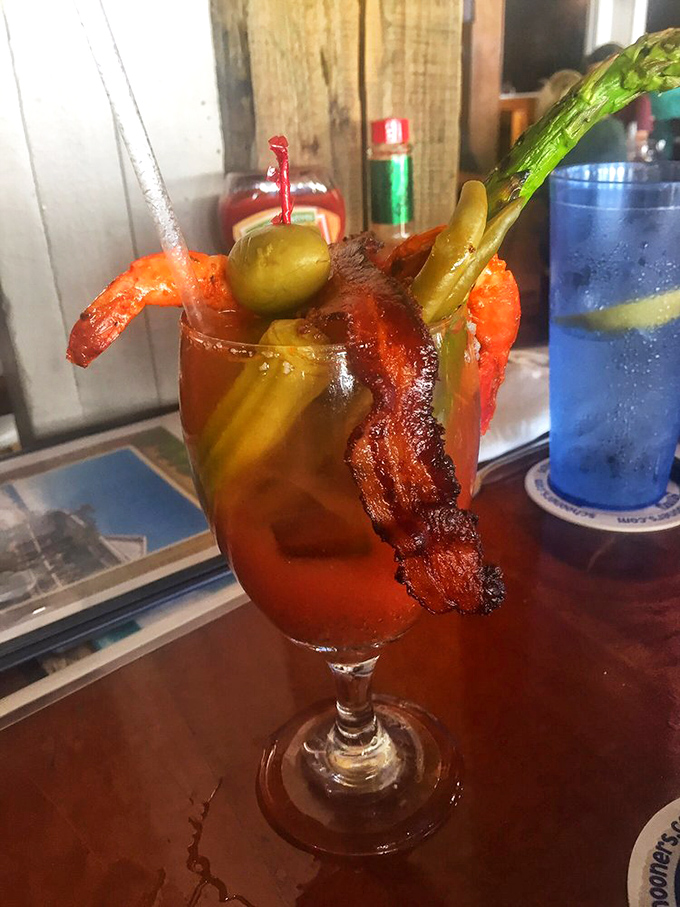 The Bloody Mary comes armed for battle with bacon, shrimp, and enough garnishes to qualify as a small appetizer. Sunday morning salvation in a glass.