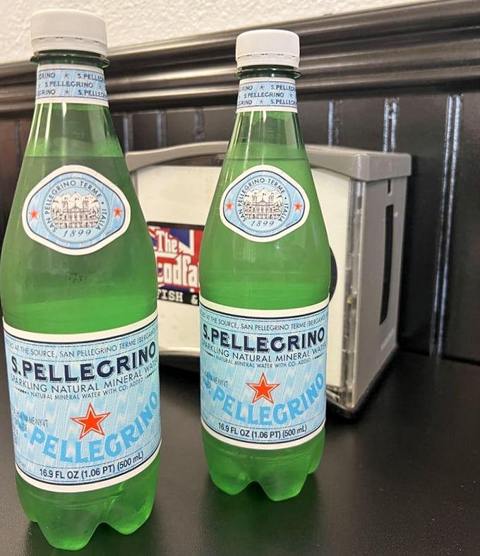 San Pellegrino bottles standing at attention like the Queen's Guard. In the Nevada heat, these sparkling sentinels offer refreshing relief between bites of crispy cod.