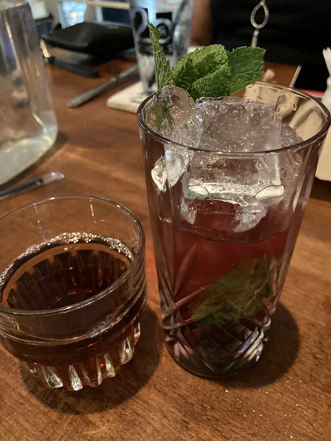 Cocktail hour done right – a perfectly crafted drink with fresh mint alongside something amber and warming. Liquid courage before ordering seconds of those mushrooms.