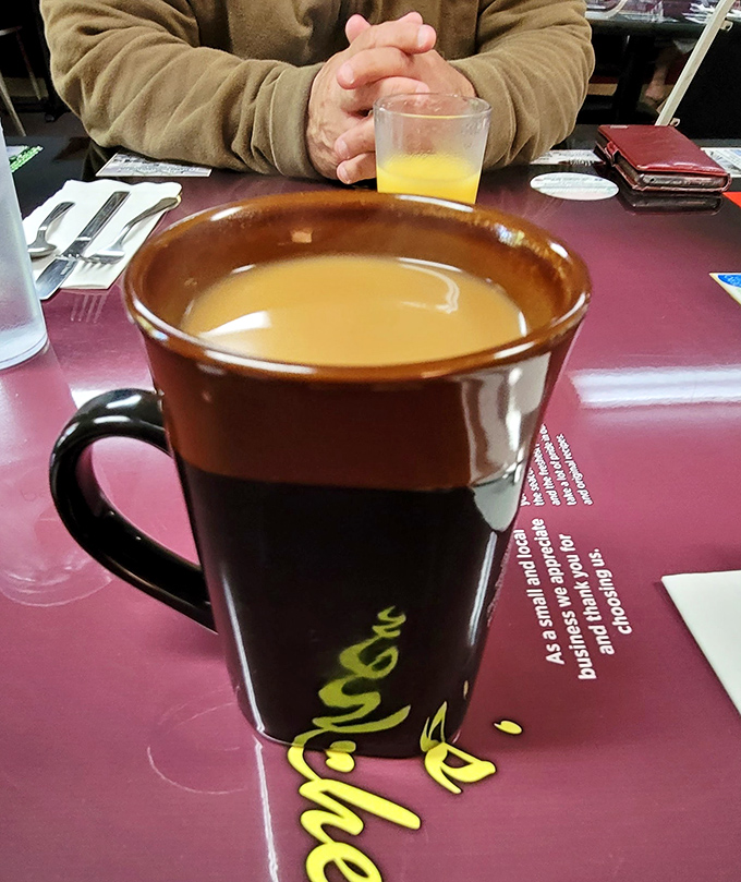 That coffee mug isn't just large &ndash; it's practically a commitment. The kind of serious caffeine vessel that says, "I've got stories to tell."