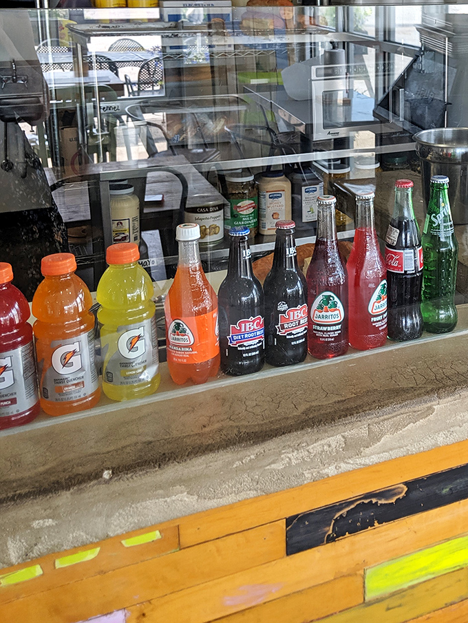 The beverage selection ranges from nostalgic glass-bottled sodas to colorful sports drinks&mdash;perfect companions for sandwich adventures.