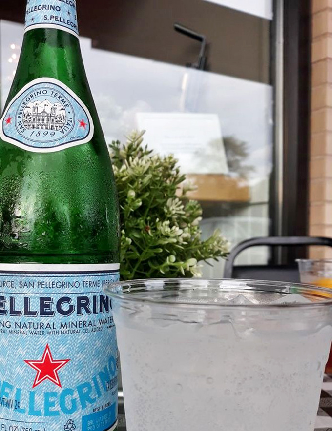 Even the San Pellegrino looks happier here, condensation glistening like morning dew. Hydration never looked so sophisticated.