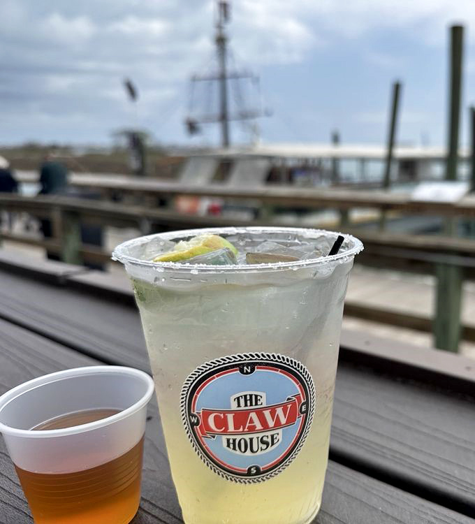 A margarita with The Claw House logo&mdash;because nothing says "vacation mode activated" like a cold drink with a water view.