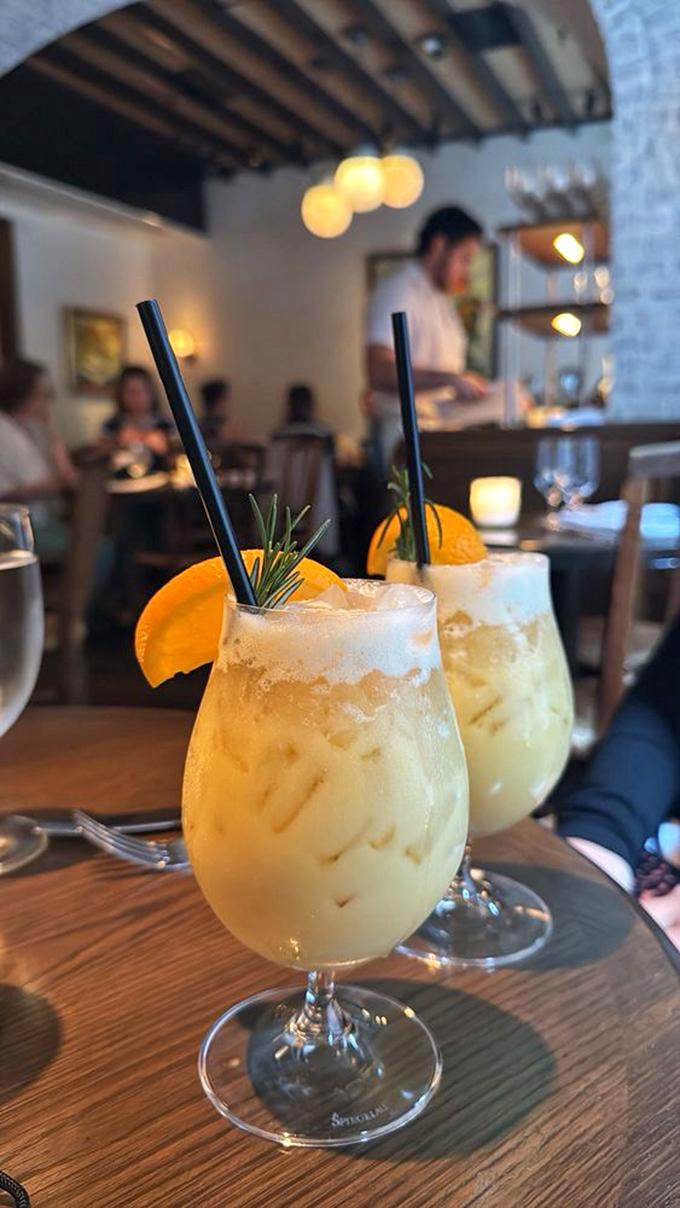 Cocktails garnished with fresh orange and rosemary&mdash;liquid sunshine in a glass that makes even Monday feel like Saturday night.