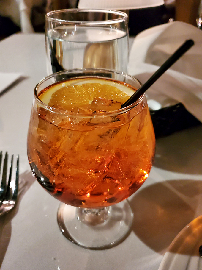An Aperol Spritz that glows like a Tuscan sunset, promising relaxation and making you temporarily forget about your mortgage payment.