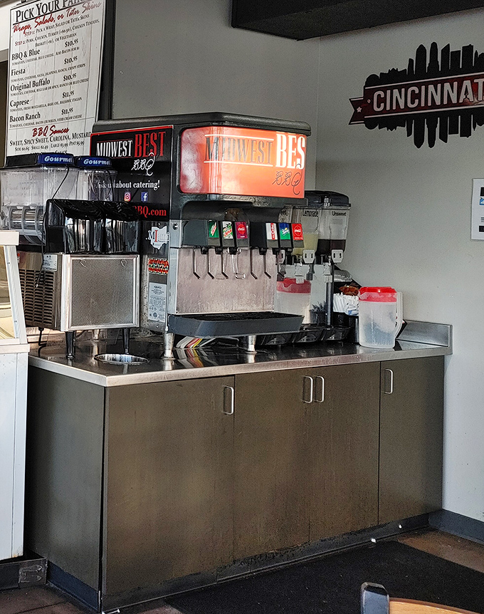 The drink station stands ready for service, with Cincinnati's skyline silhouette watching approvingly from the wall &ndash; local pride meets thirst quenching.