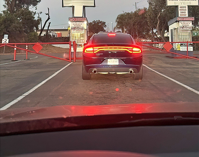 The moment of arrival—cars queue up at dusk, headlights glowing with anticipation for the night's double feature.