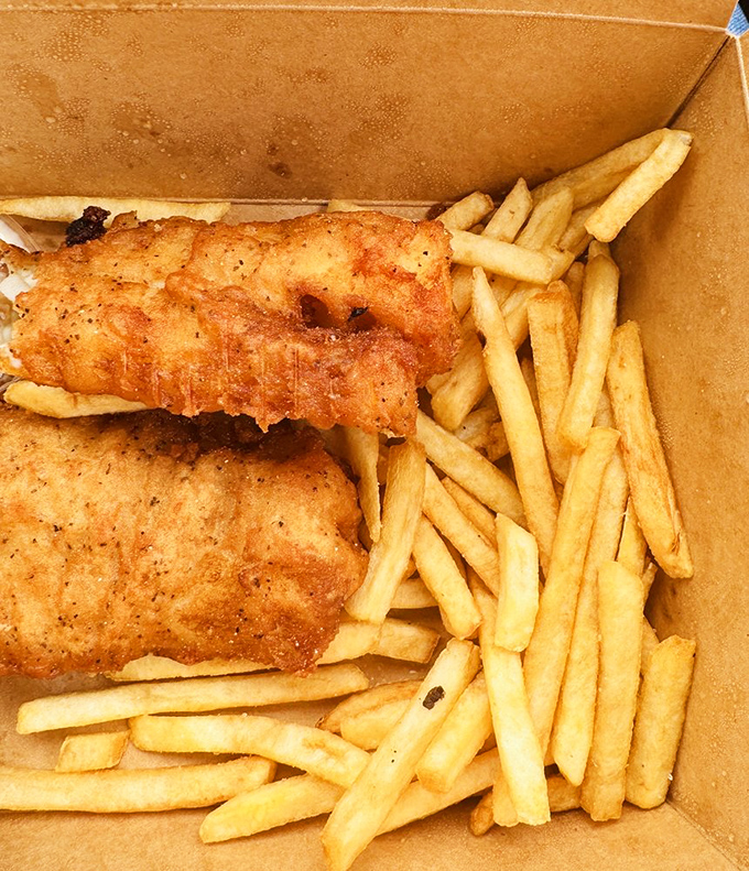 Fish and chips that crunch louder than your childhood cereal, served in a box that says "I'm casual" but tastes like "I'm spectacular."